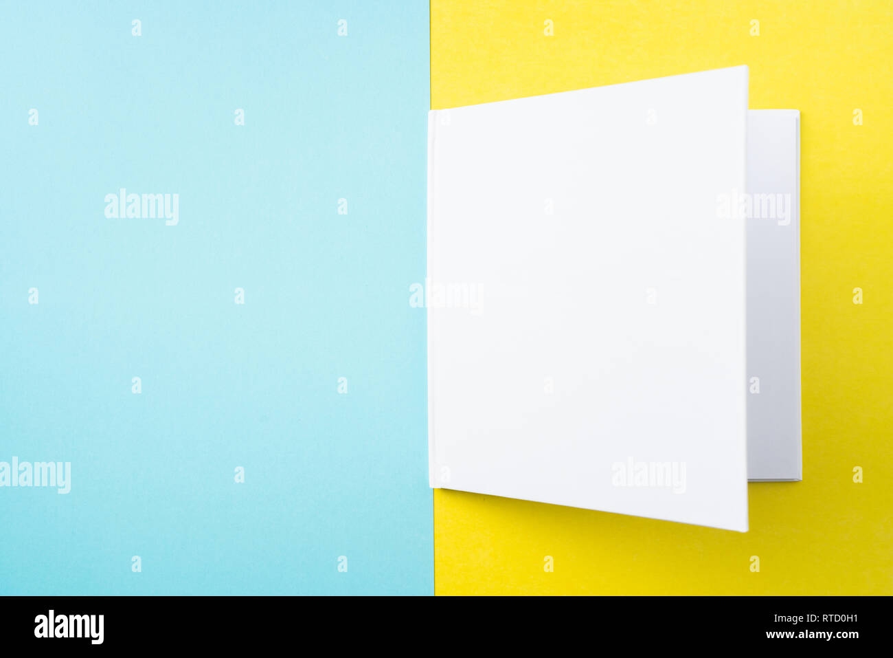 Design concept - Top view of opening square white notebook on colorful ...