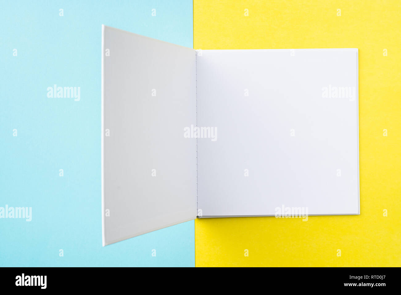 Design concept - Top view of opening square white notebook on colorful ...