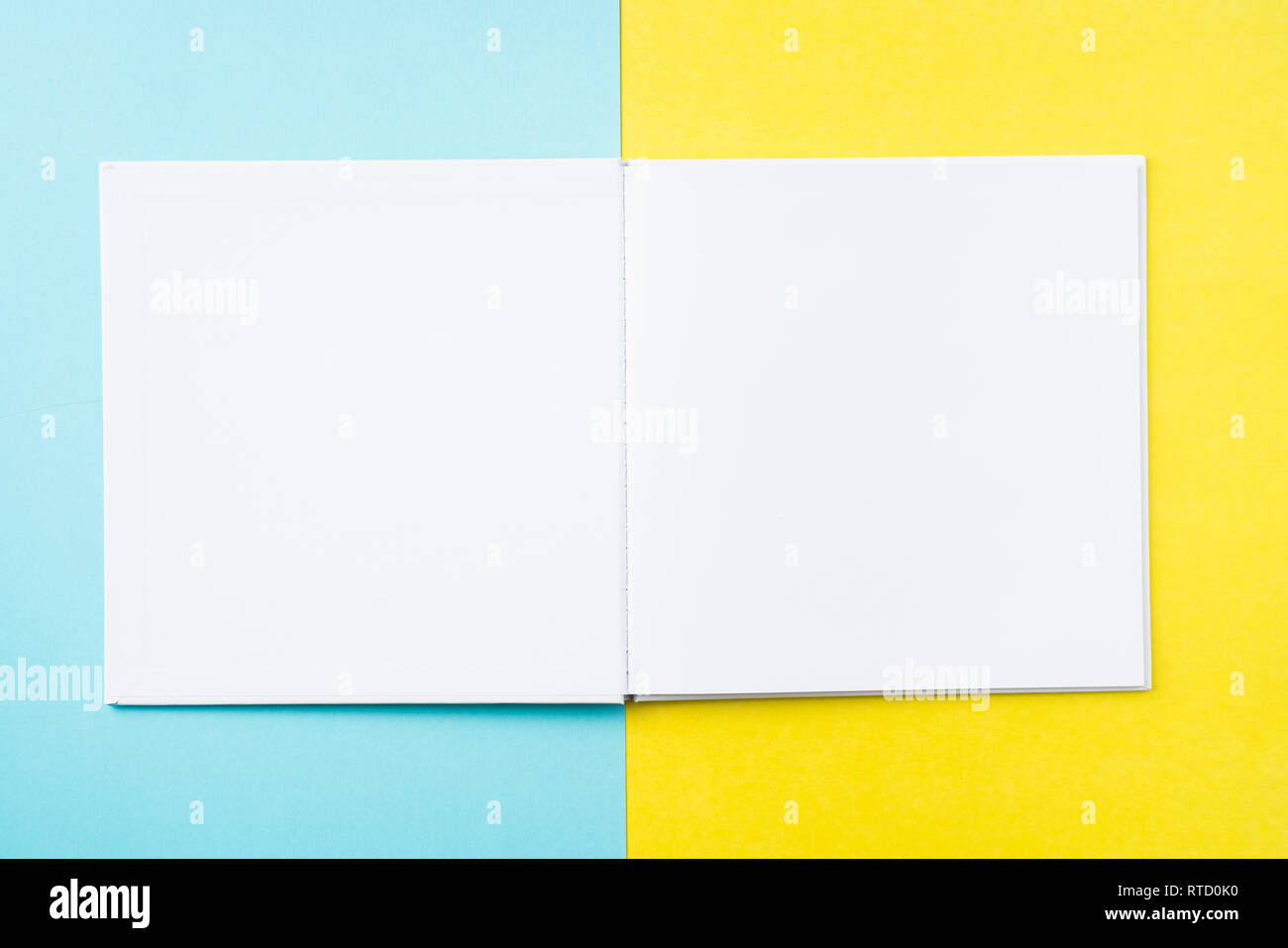 Design concept - Top view of opening square white notebook on colorful ...