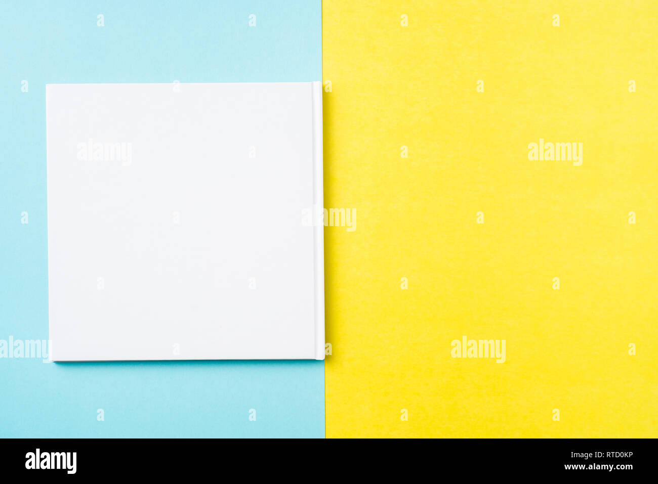Design concept - Top view of opening square white notebook on colorful ...