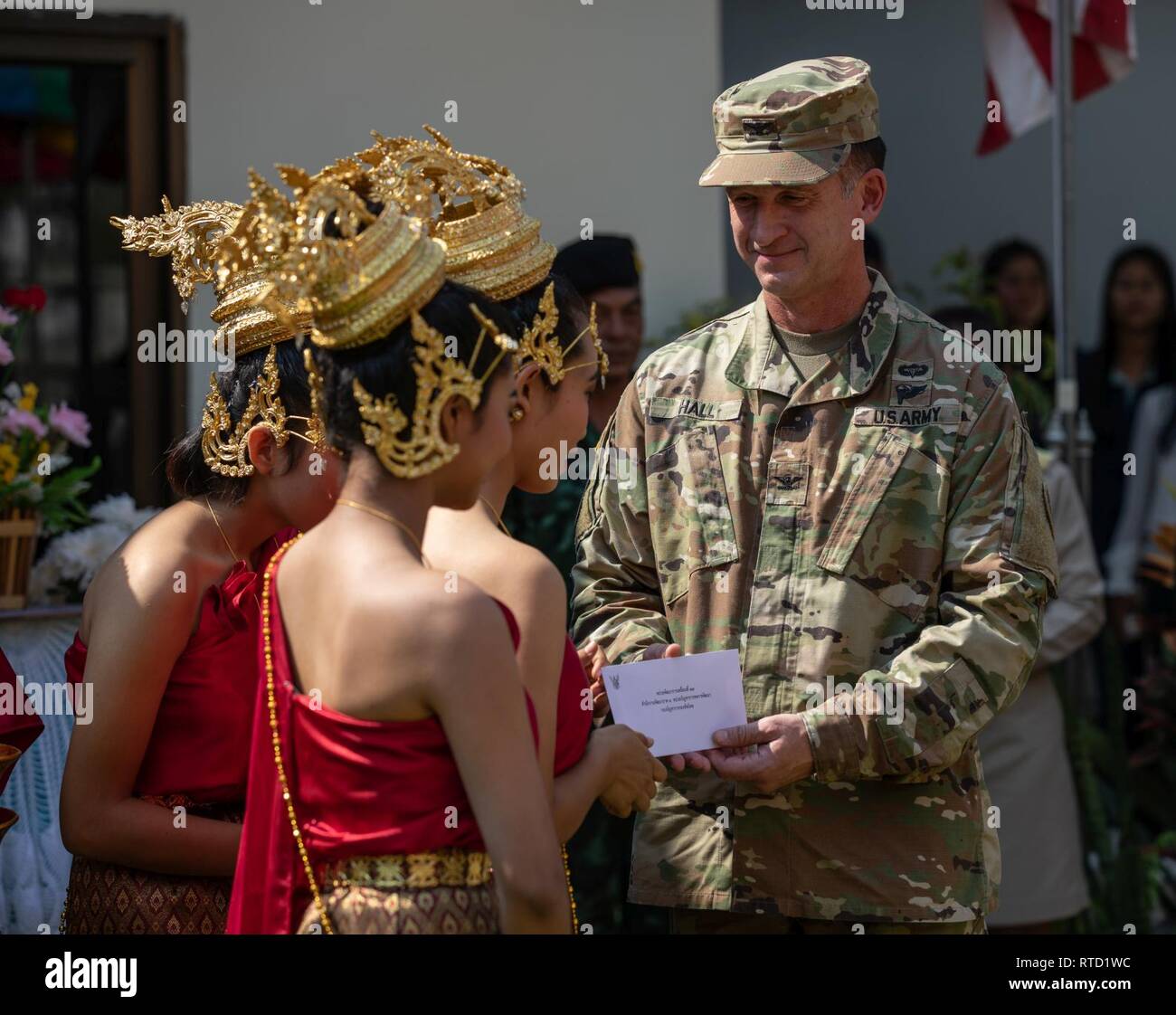 U.S. Army Col. Jerry Hall, US Army Pacific hands an envelope to school ...