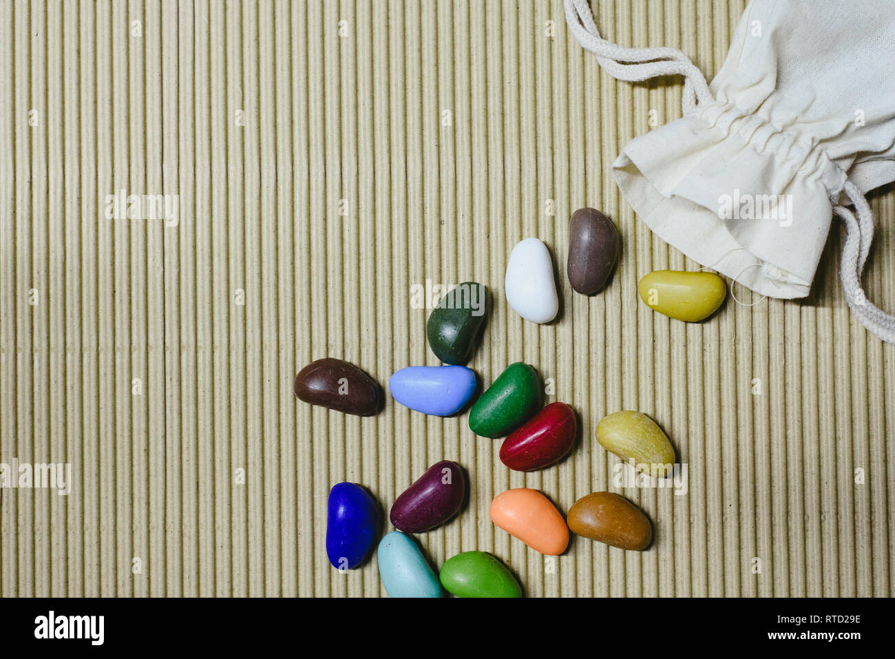 Background of colored fake stones scattered on a wavy paper with cloth ...