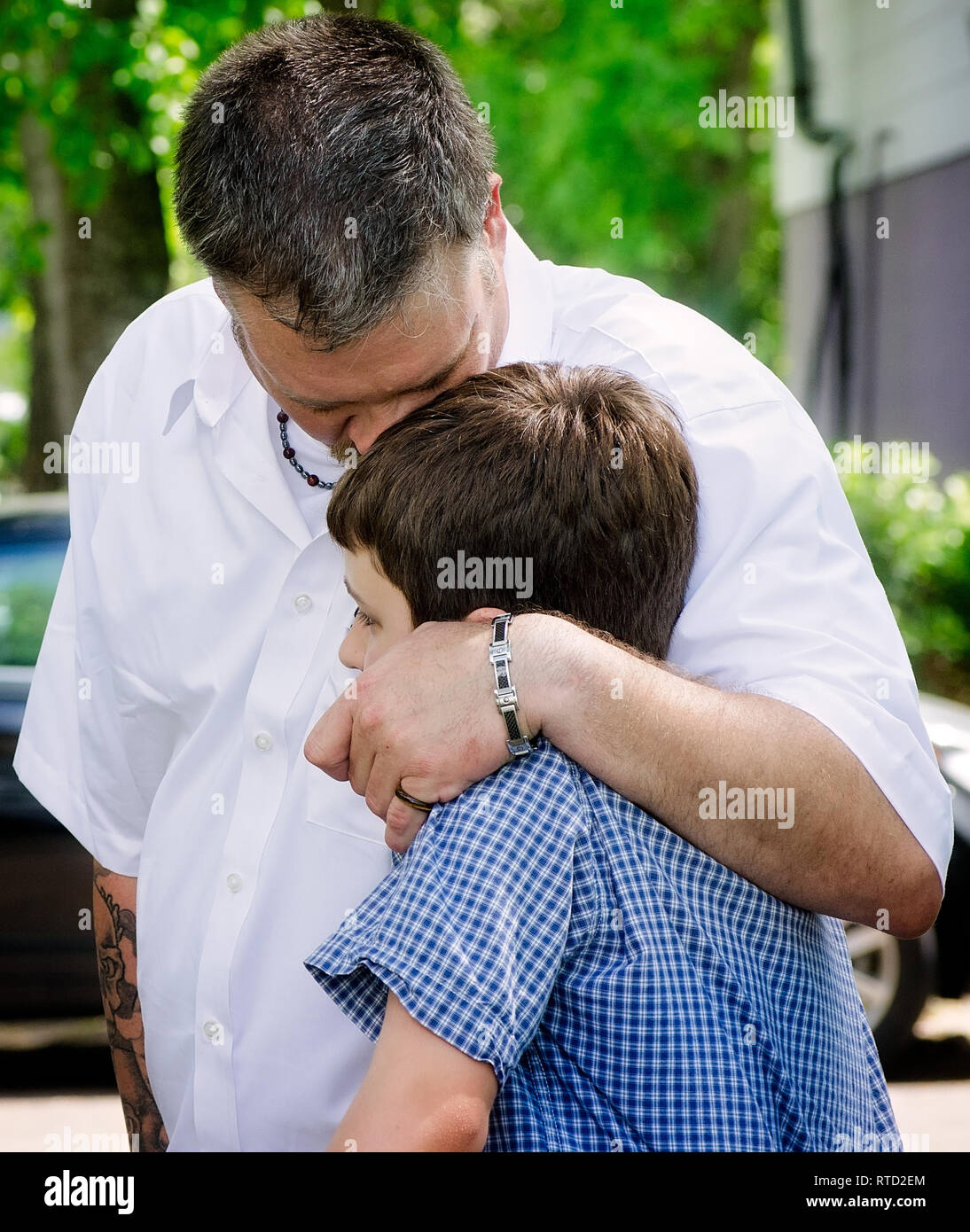 Father And Teenage Son Hugging