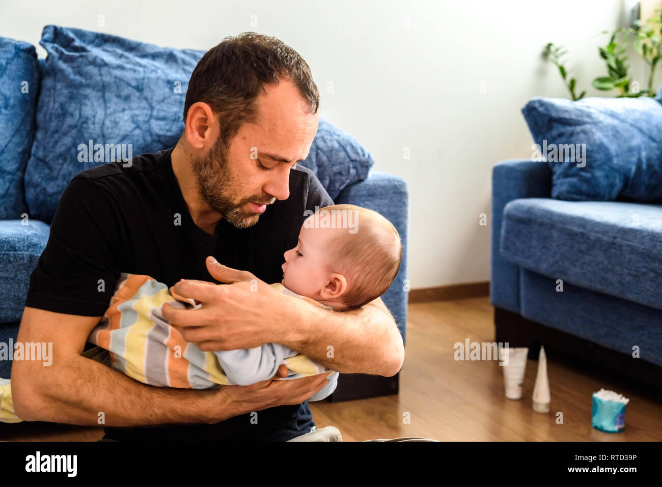 Baby and father embraced affectionately Stock Photo - Alamy