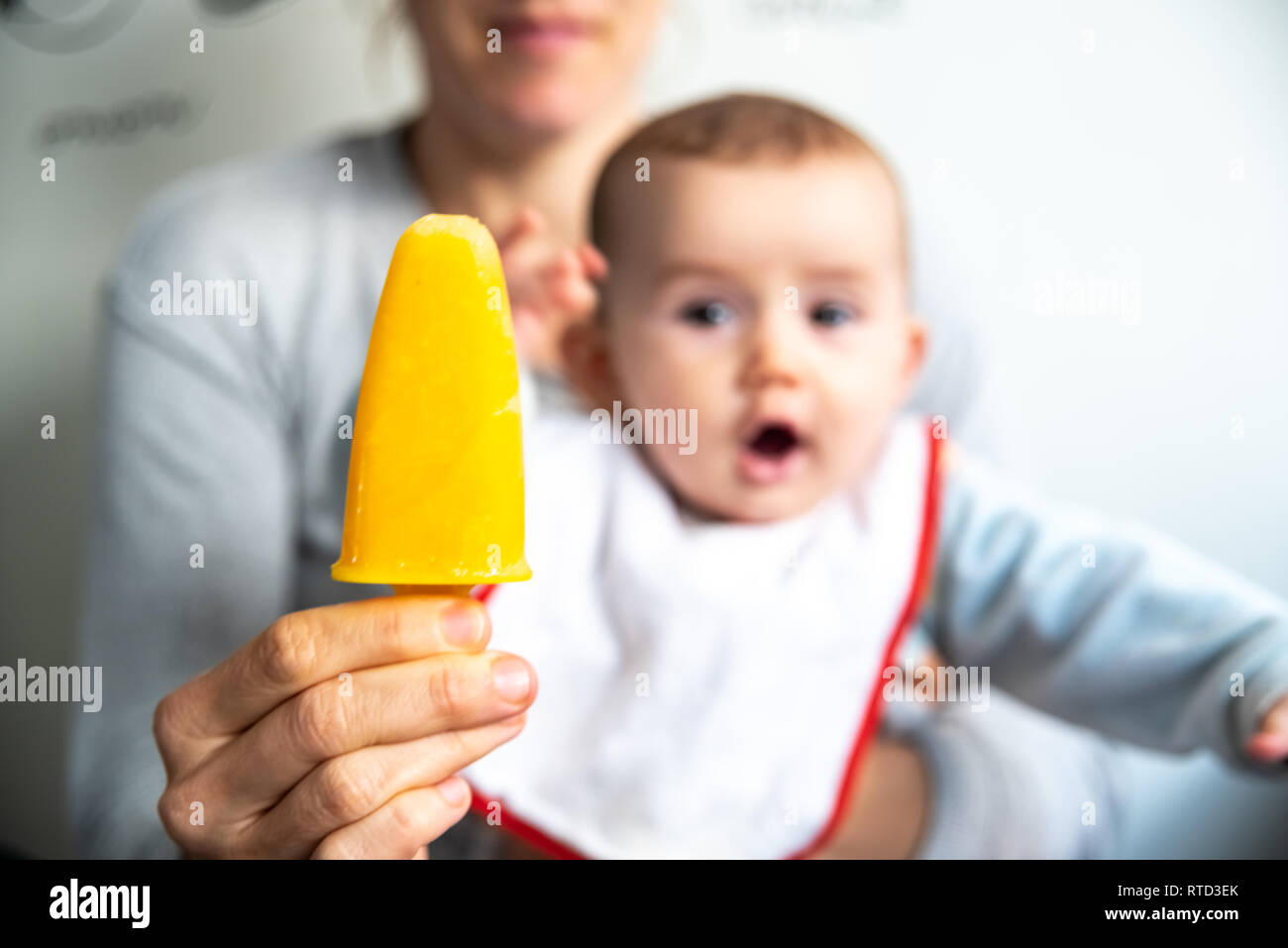 Baby smiling and drooling when trying for the first time an ice cream ...
