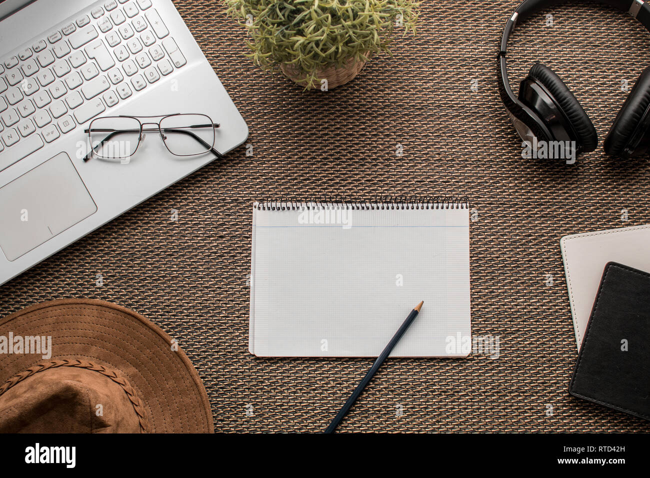 Flat lay. Top view of an office with laptop, notebook, hat, pencil ...
