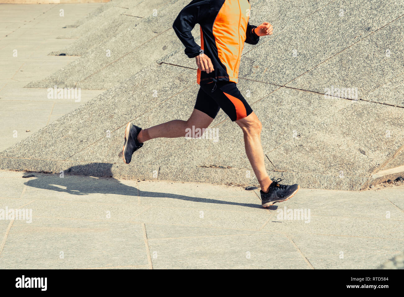 Runner man with sportswear training running in urban environment at the ...