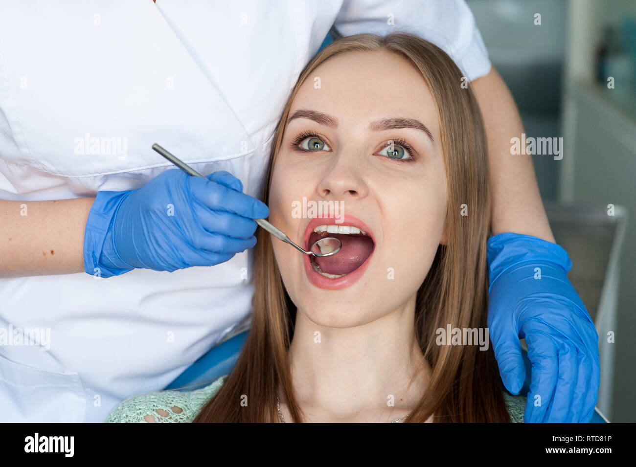 Dental clinic. Dentist examining a patient's teeth Stock Photo - Alamy