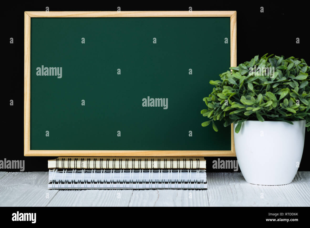 Back to school and education concept idea, green chalkboard with pile ...