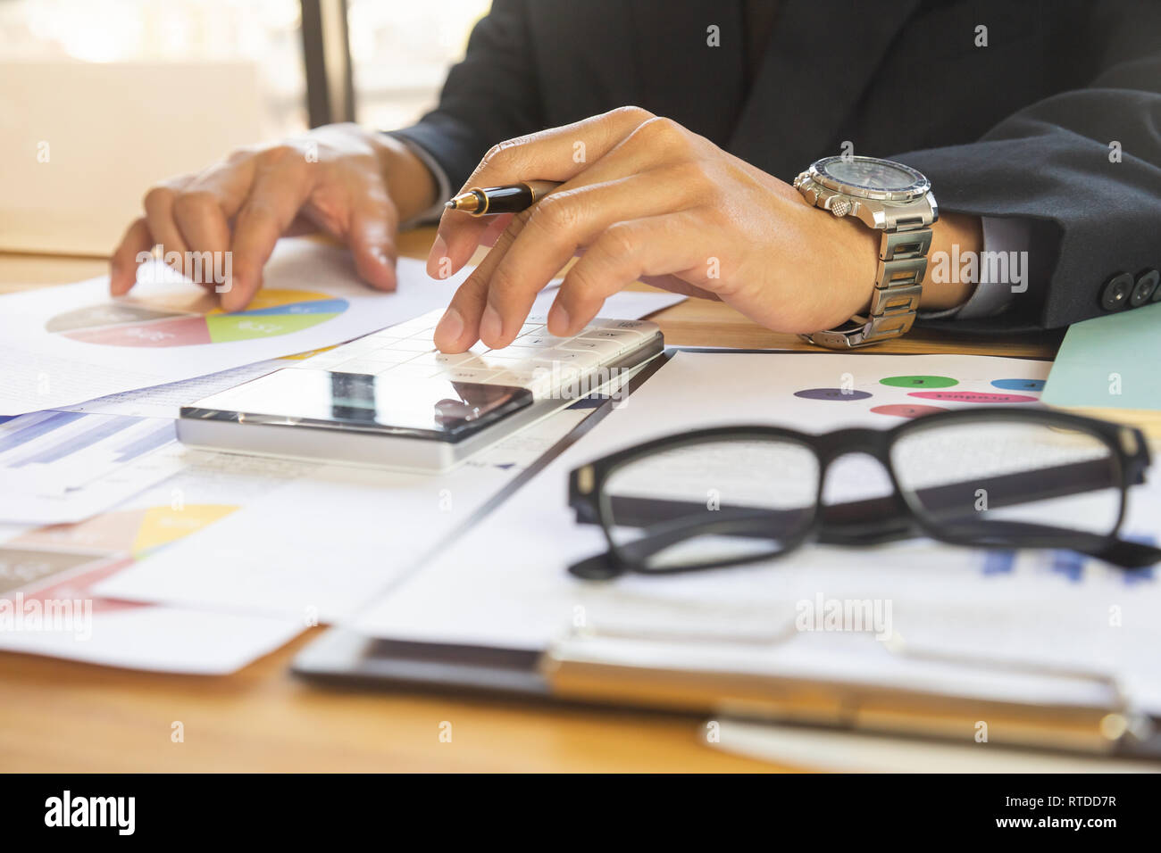 Businessman or accountant working on calculator to calculate business ...
