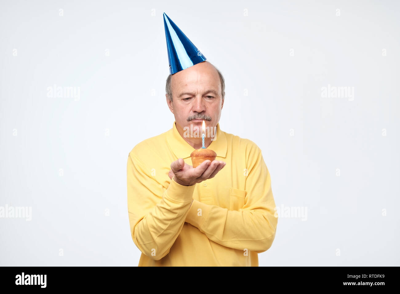 Human facial expressions. Sad father wearing cone hat and shirt looking ...