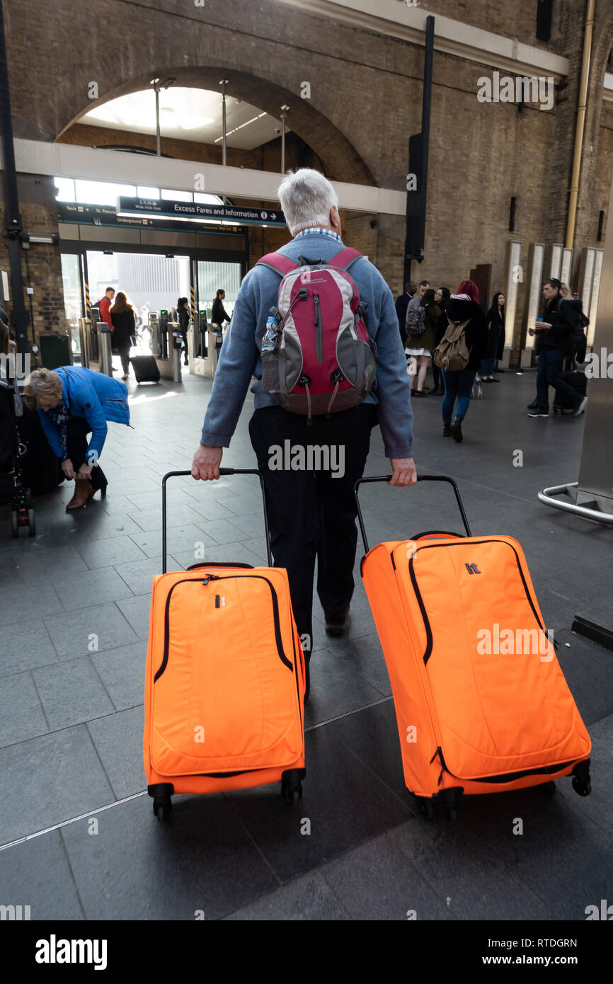 Two man pulling luggage bag hi-res stock photography and images - Alamy