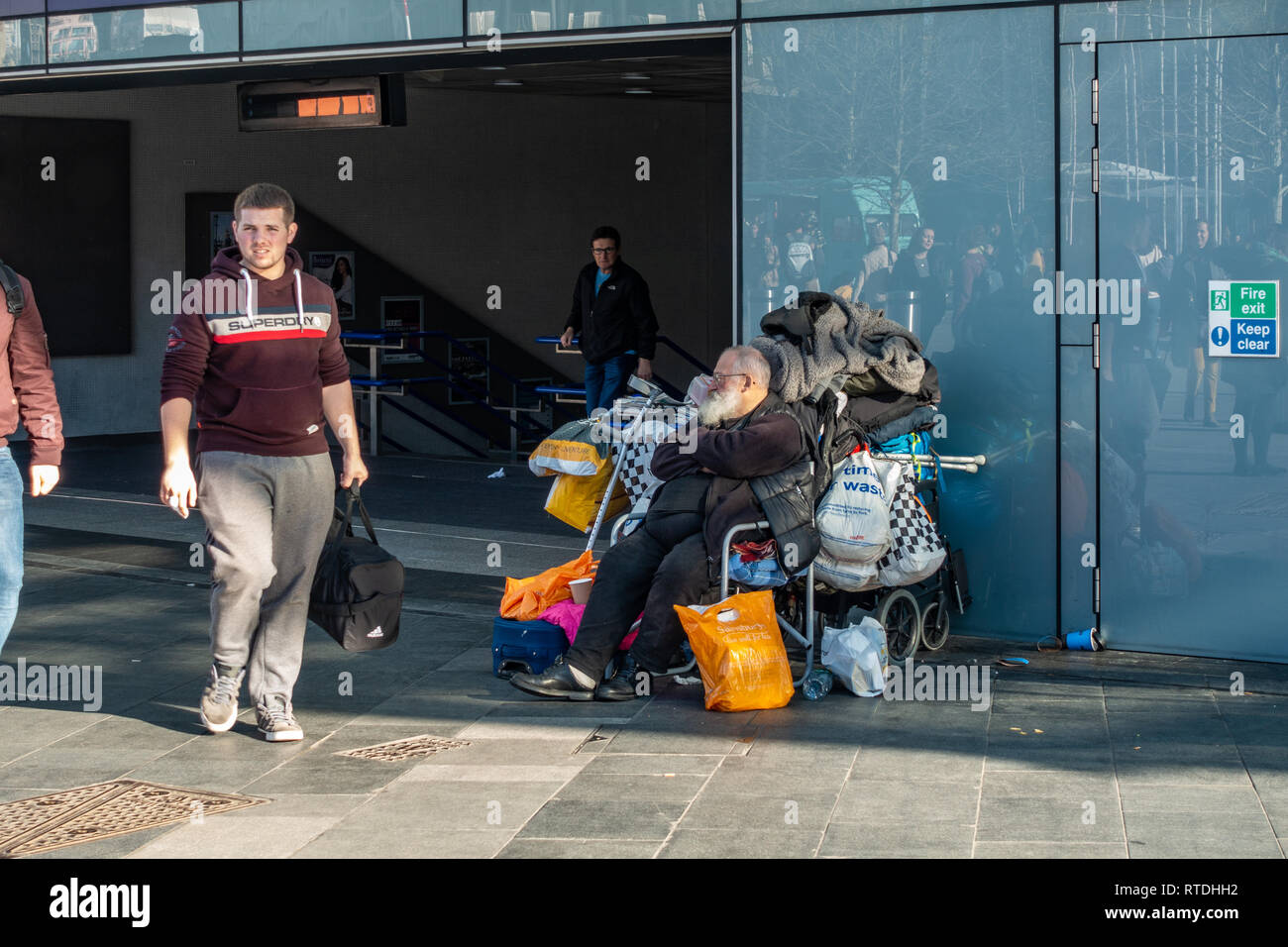 Old Homeless man sitting in his chair surounded by all his many items ...