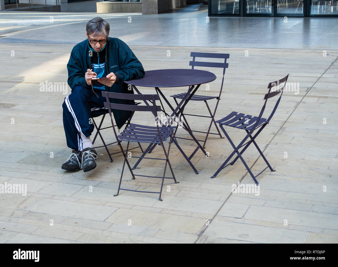 Young man reading in a courtyard hi-res stock photography and images ...