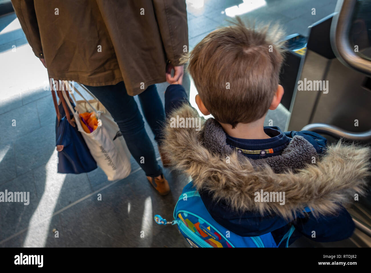 Adult woman leading a young boy by the hand Stock Photo - Alamy