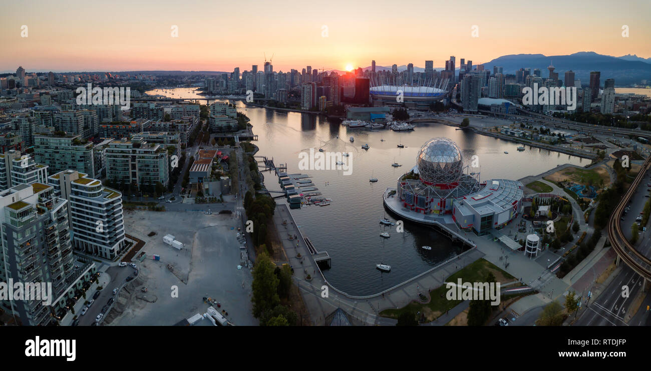 Aerial Panoramic view of a modern city during a sunny summer sunset ...