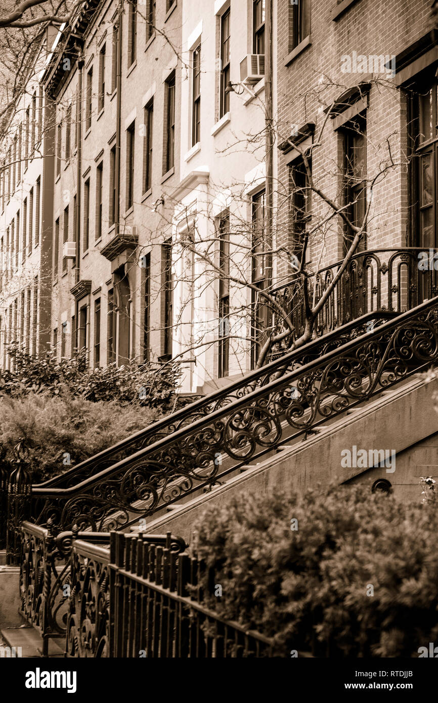 View of apartment buildings and brownstones along pretty street in New ...