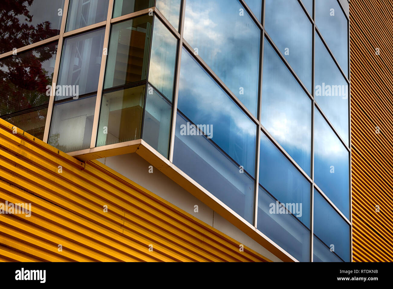 Abstract yellow modern building exterior with glass window in daylight ...