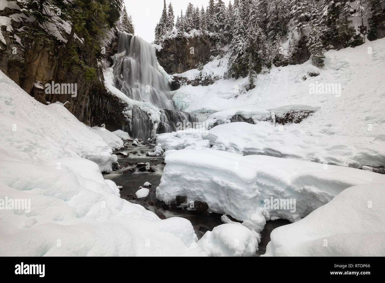 Beautiful Canadian Winter Landscape of the Waterfall during a white ...