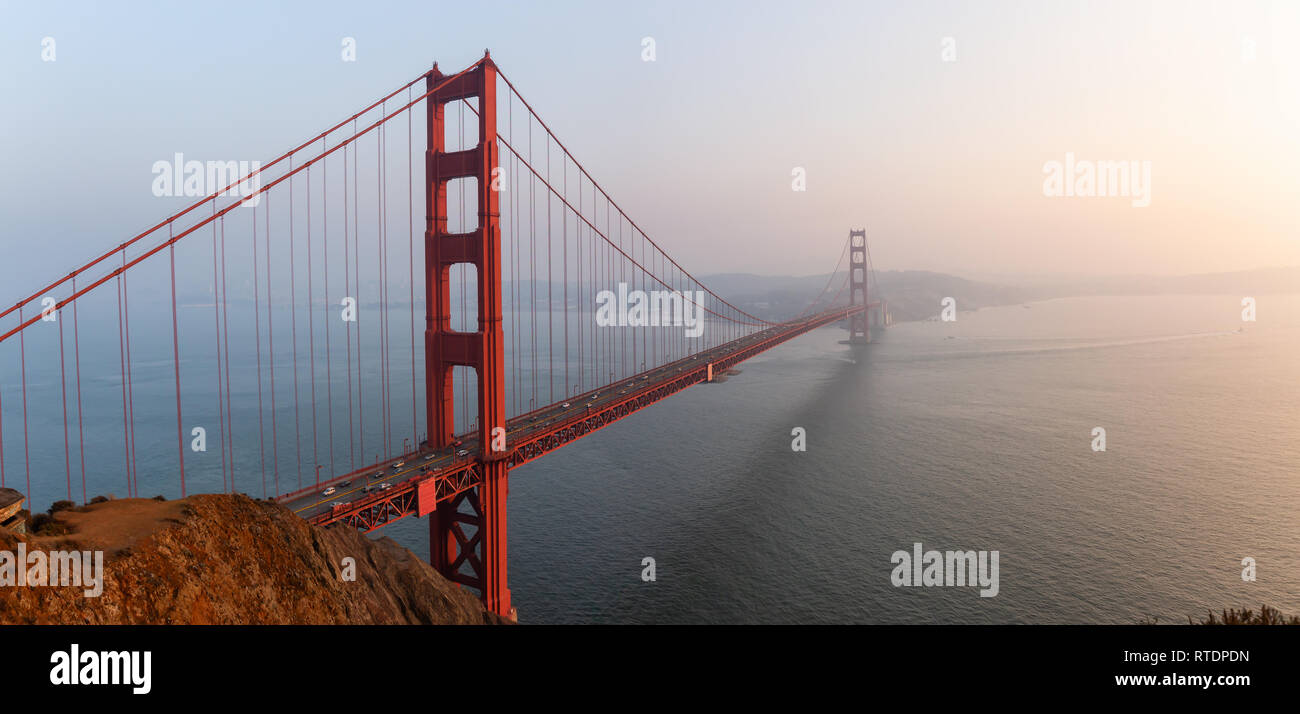 Beautiful panoramic view of Golden Gate Bridge during a hazy sunset ...
