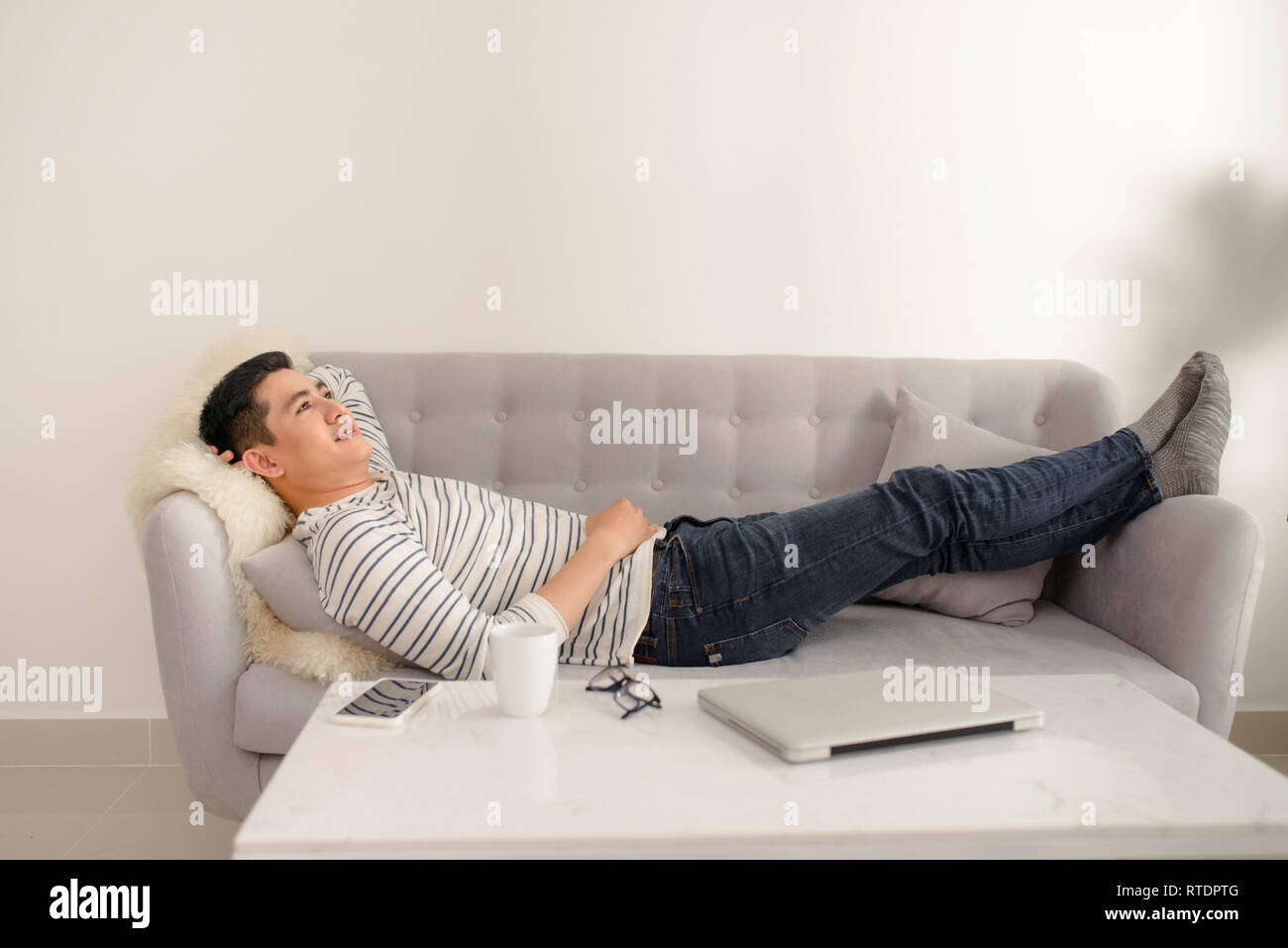 Man daydreaming sitting on couch hi-res stock photography and images ...