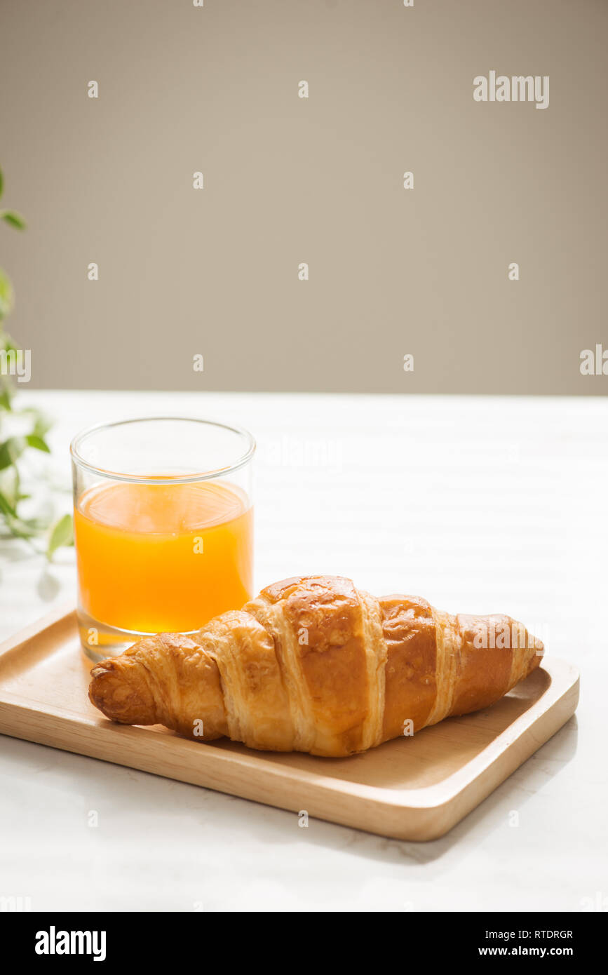 Morning breakfast with croissant and fruit juice Stock Photo - Alamy