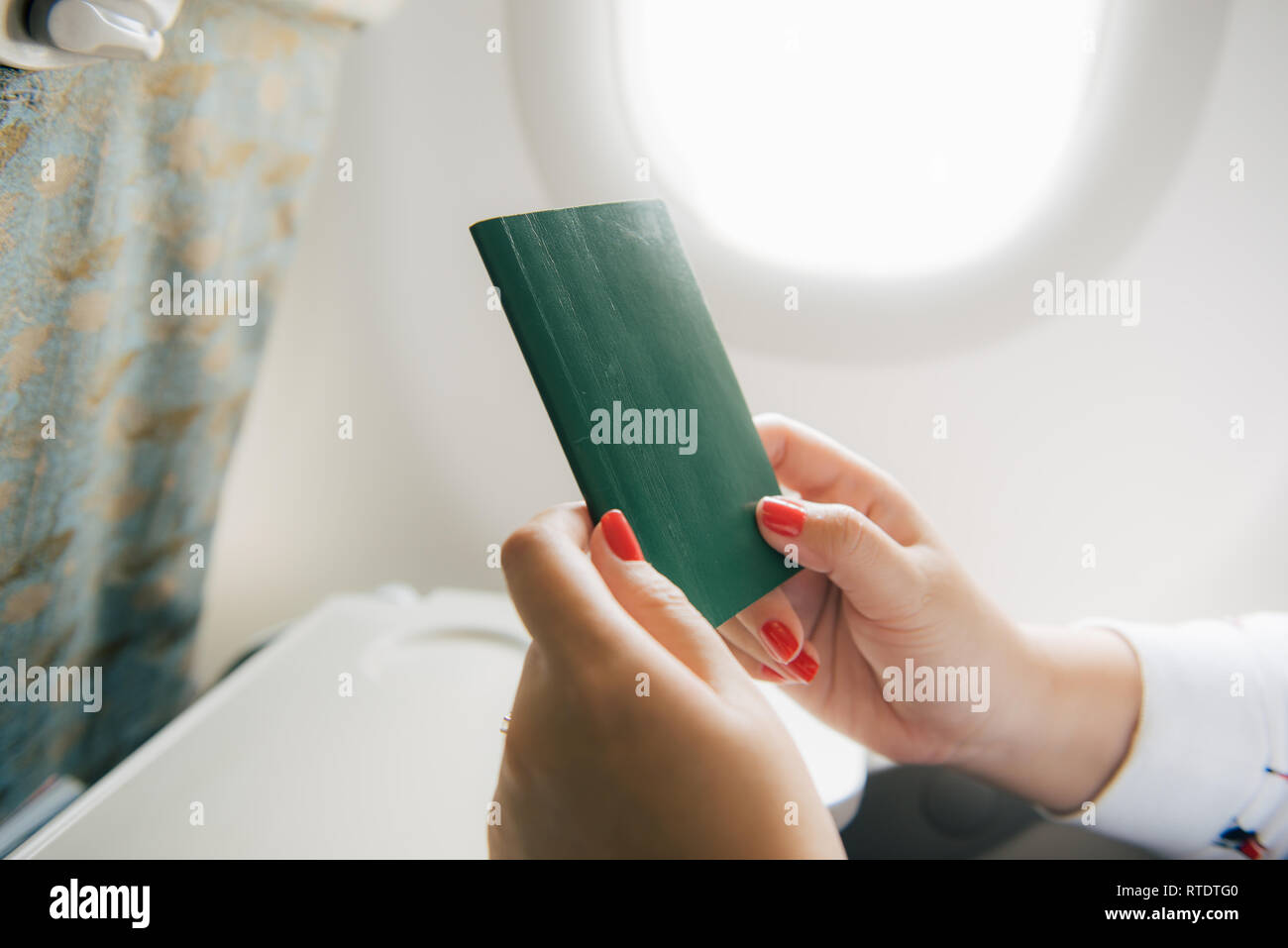 Airplane vacation journey. Man with passport and ticket sitting next to ...