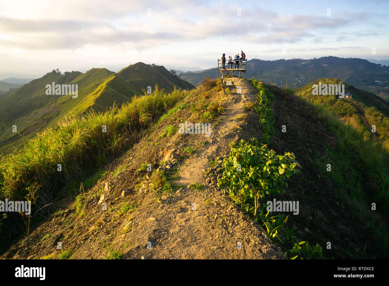 Group of hikers enjoying morning view at hilly mountain range with ...