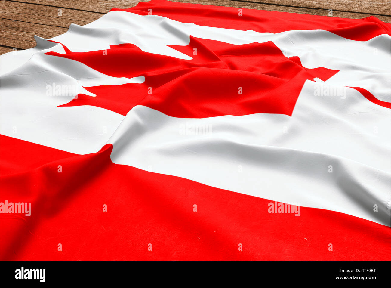 Flag of Canada on a wooden desk background. Silk Canadian flag top view ...