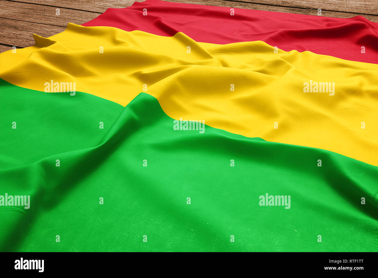 Flag of Mali on a wooden desk background. Silk Malian flag top view ...