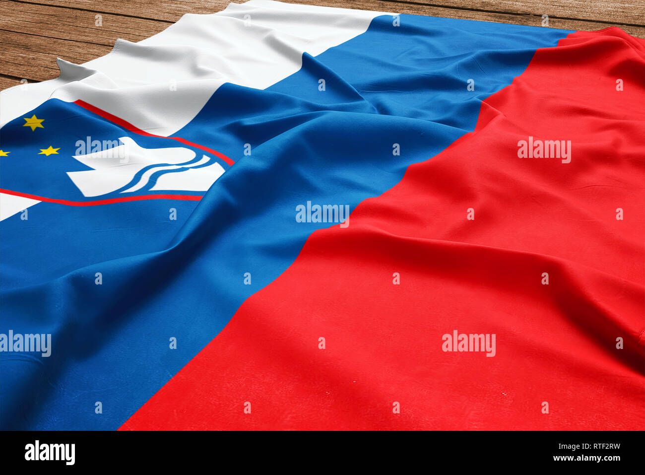 Flag of Slovenia on a wooden desk background. Silk Slovene flag top ...