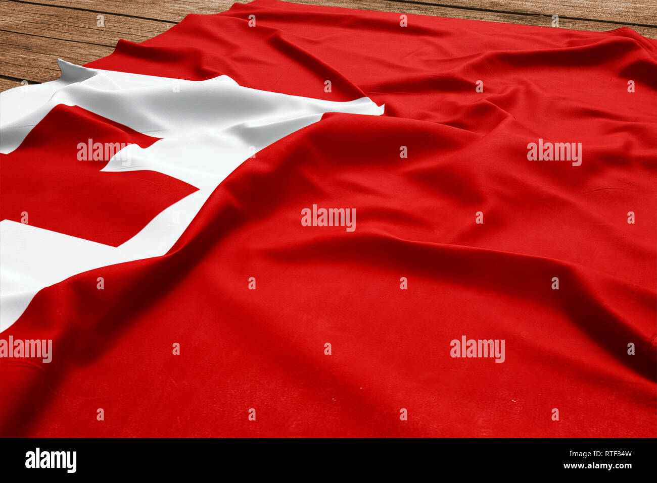 Flag of Tonga on a wooden desk background. Silk Tongan flag top view ...