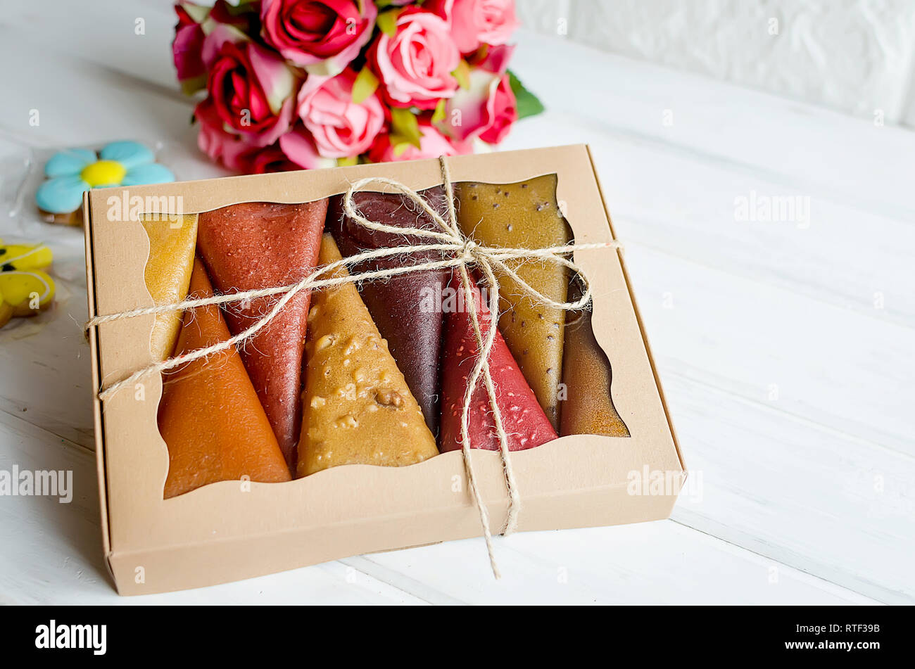 fruit pastille fruit leather cones in a gift box vith roses bouquet on ...