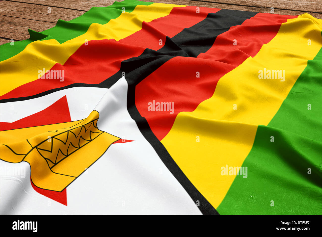 Flag of Zimbabwe on a wooden desk background. Silk Zimbabwean flag top ...