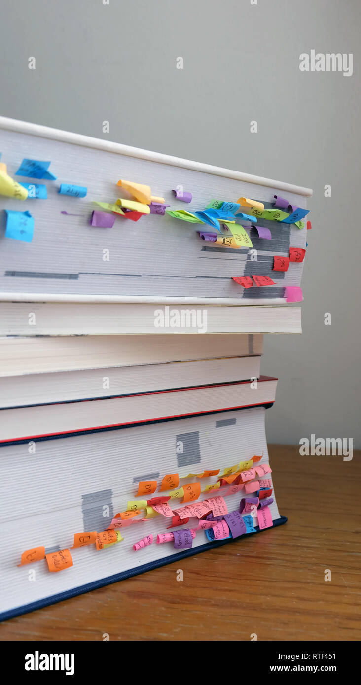 Stack of books with colorful paper markings on the side of the books ...