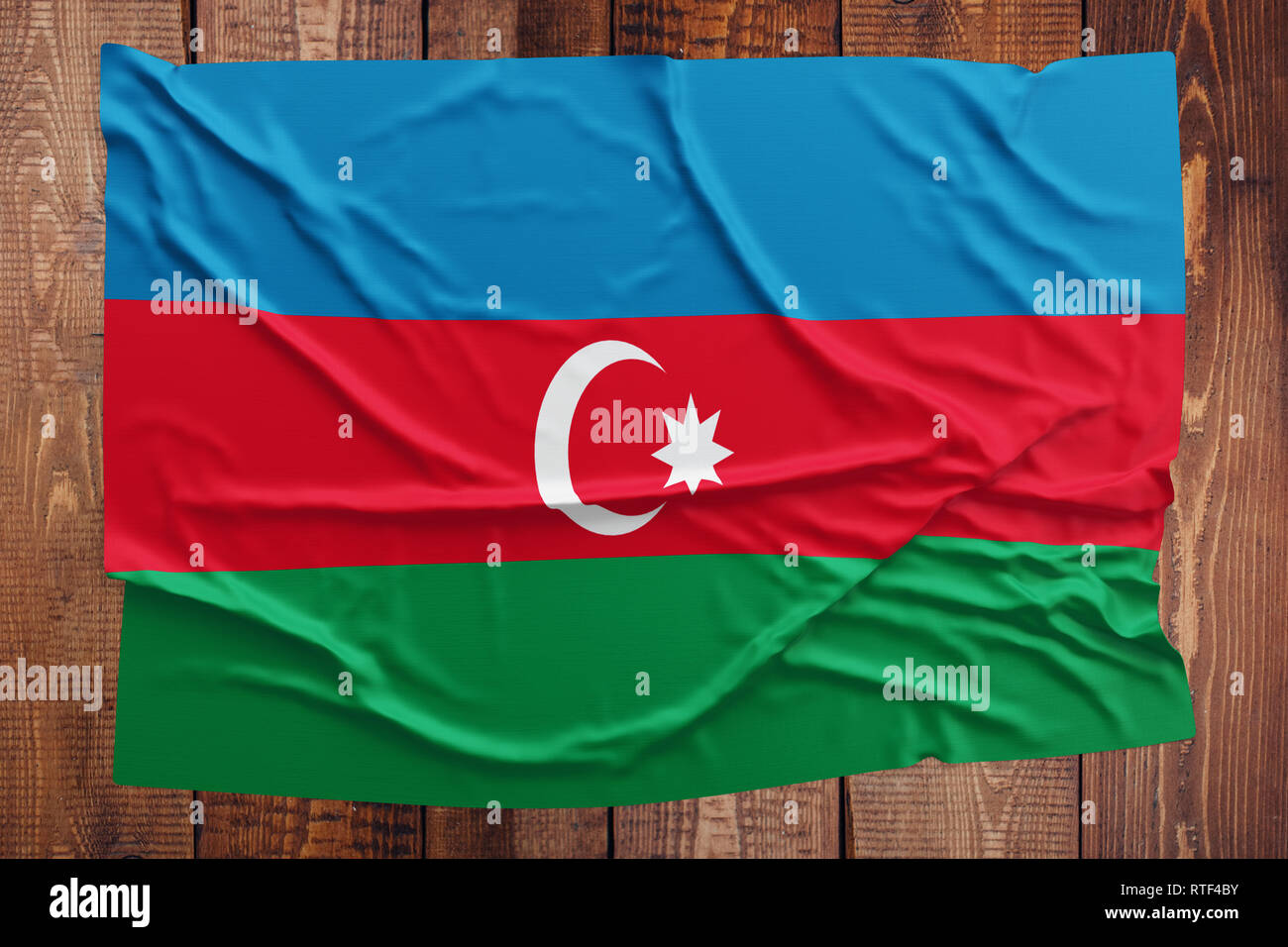 Flag of Azerbaijan on a wooden table background. Wrinkled Azerbaijani ...