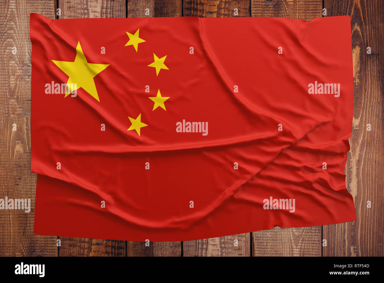 Flag of China on a wooden table background. Wrinkled Chinese flag top ...