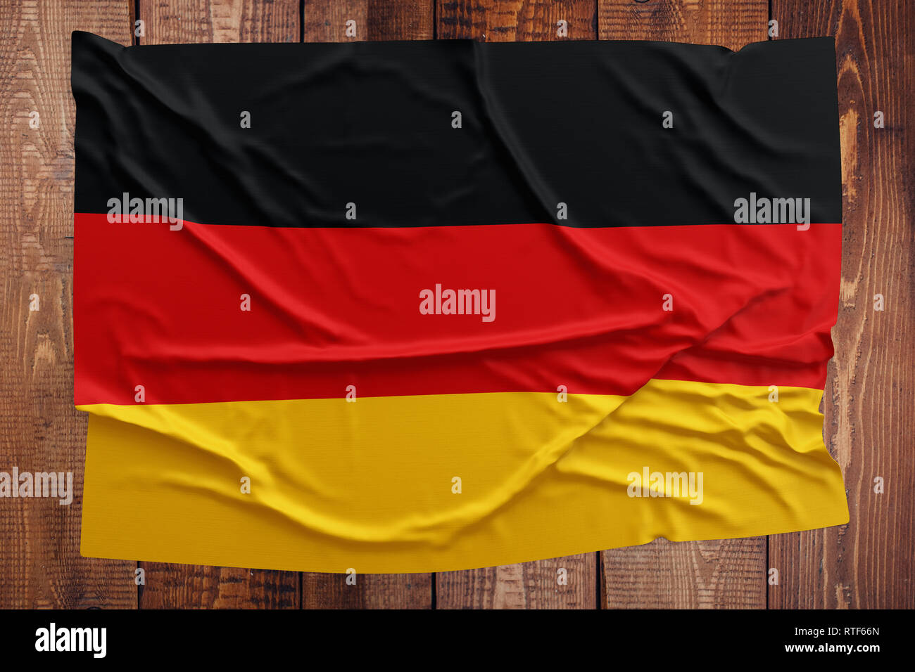 Flag of Germany on a wooden table background. Wrinkled German flag top ...