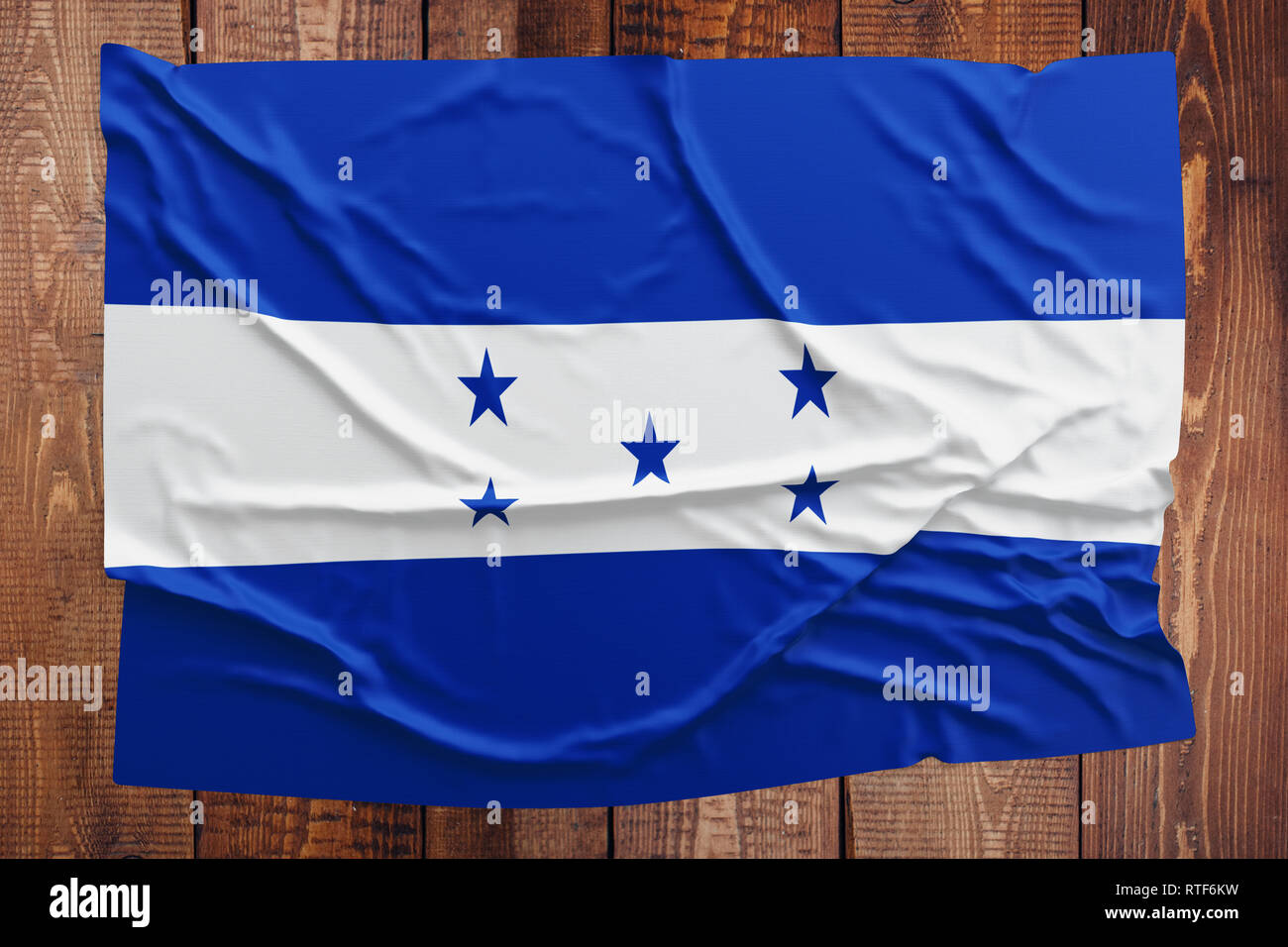Flag of Honduras on a wooden table background. Wrinkled Honduran flag ...