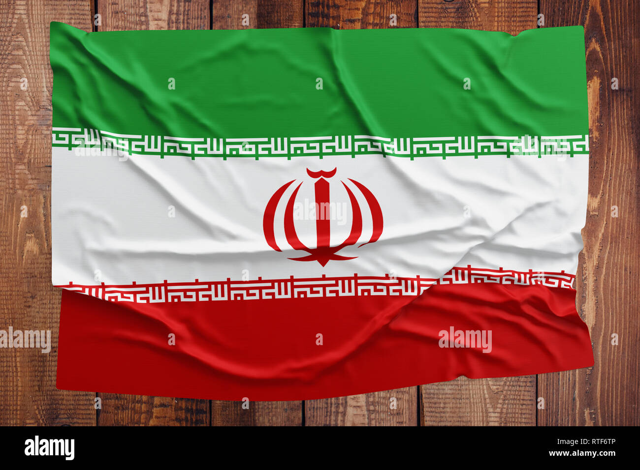 Flag of Iran on a wooden table background. Wrinkled Iranian flag top ...