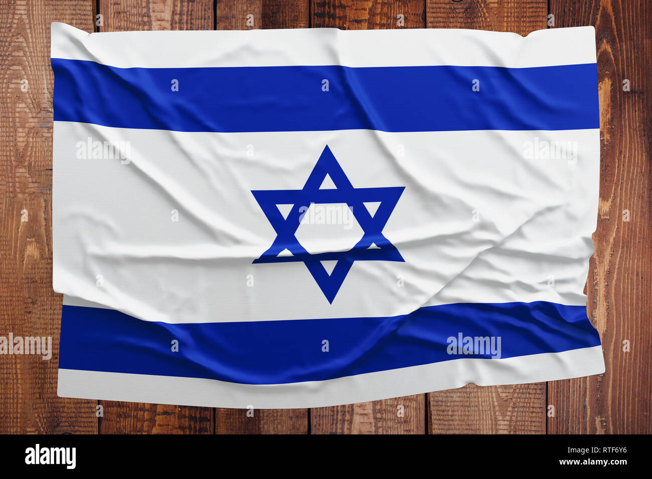 Flag of Israel on a wooden table background. Wrinkled Israeli flag top ...