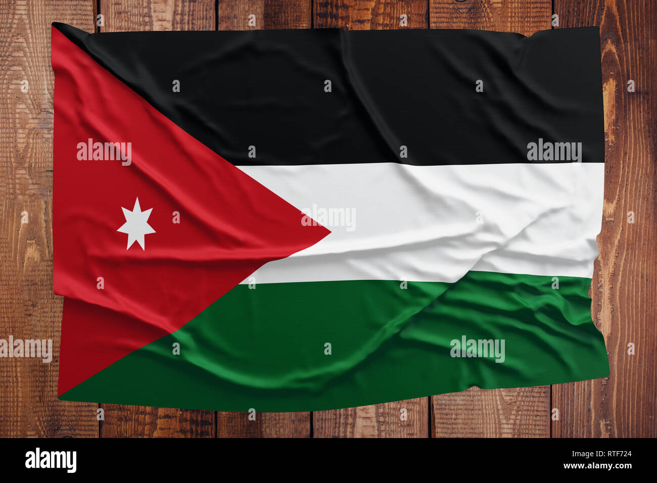 Flag of Jordan on a wooden table background. Wrinkled Jordanian flag ...