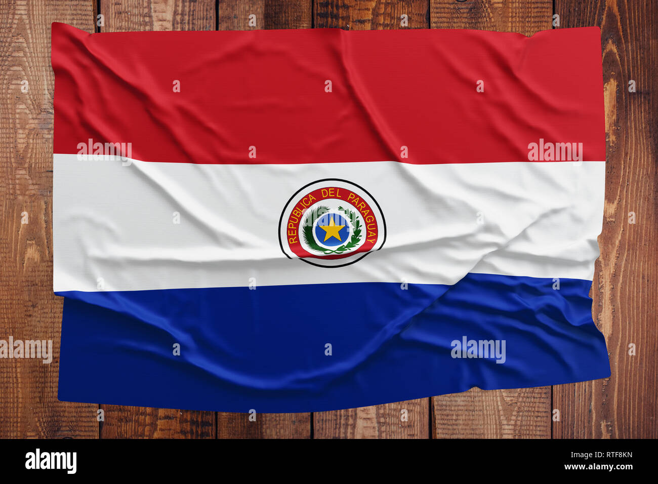 Flag of Paraguay on a wooden table background. Wrinkled Paraguayan flag ...