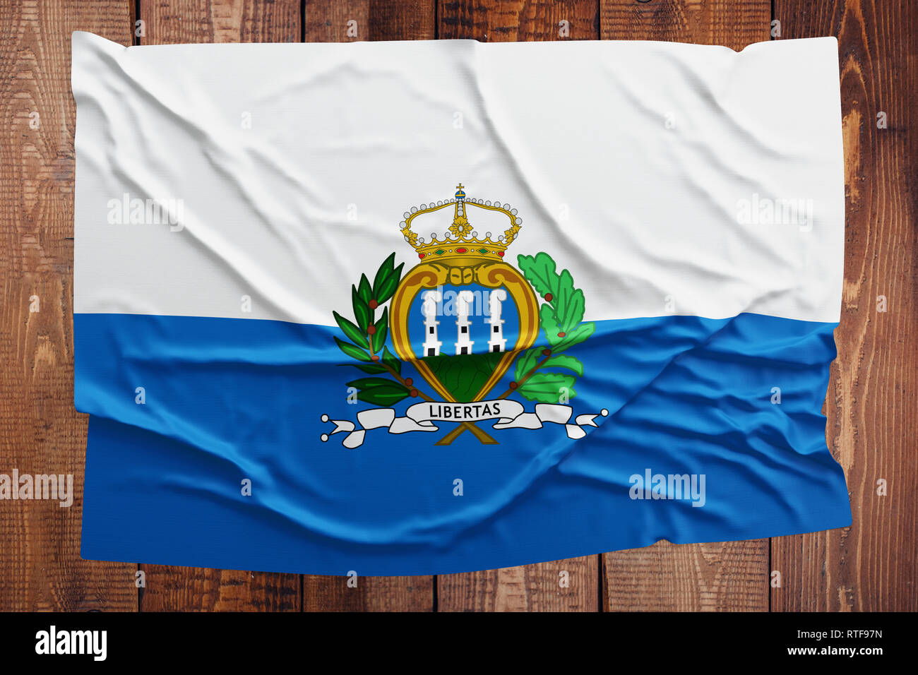 Flag of San Marino on a wooden table background. Wrinkled Sammarinese ...
