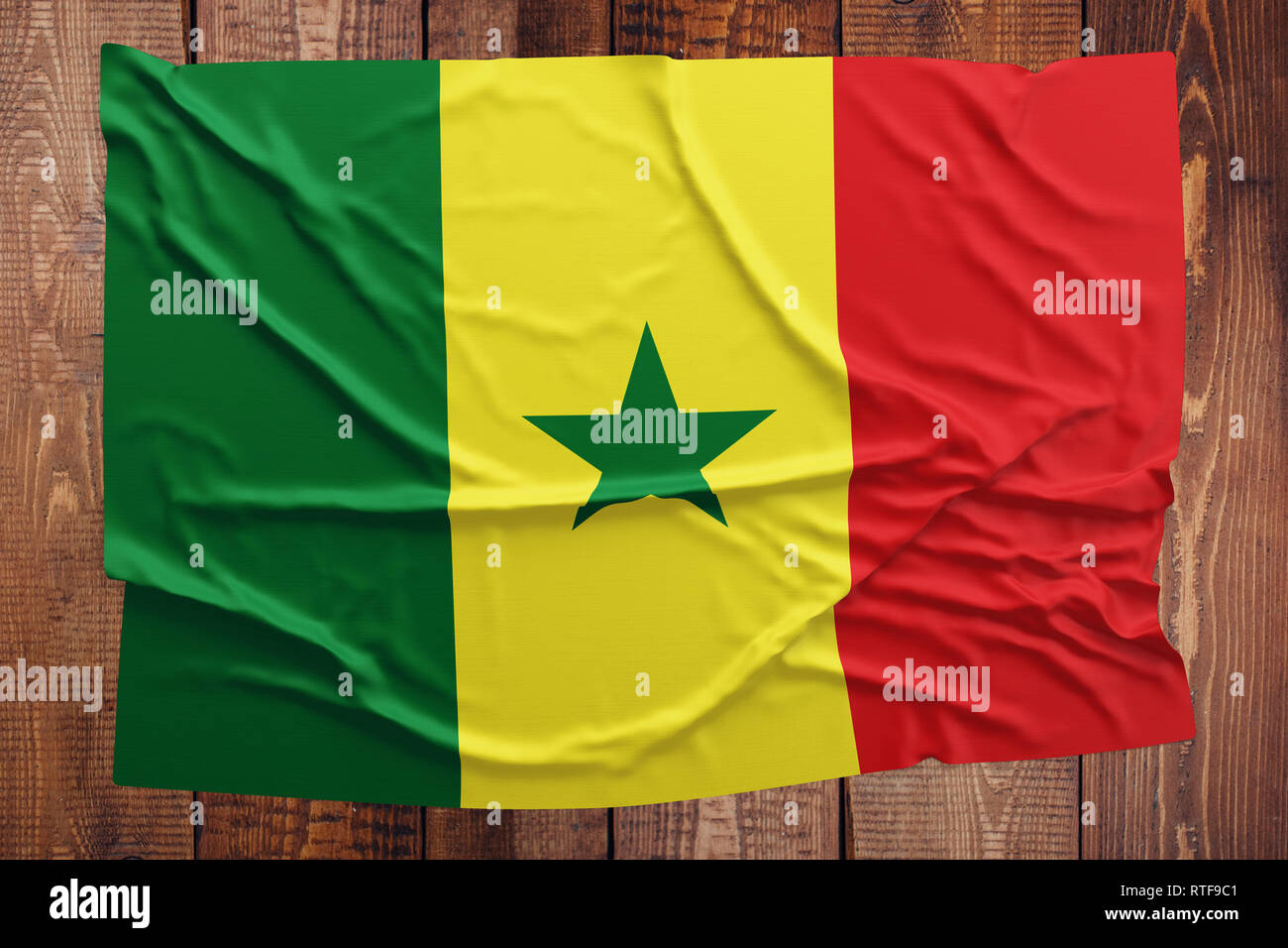 Flag of Senegal on a wooden table background. Wrinkled Senegalese flag ...