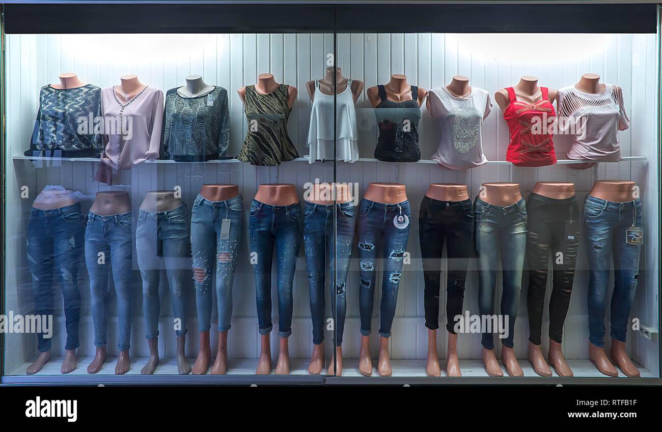 Shop window with busts of fashionable T-shirts, and legs with jeans ...