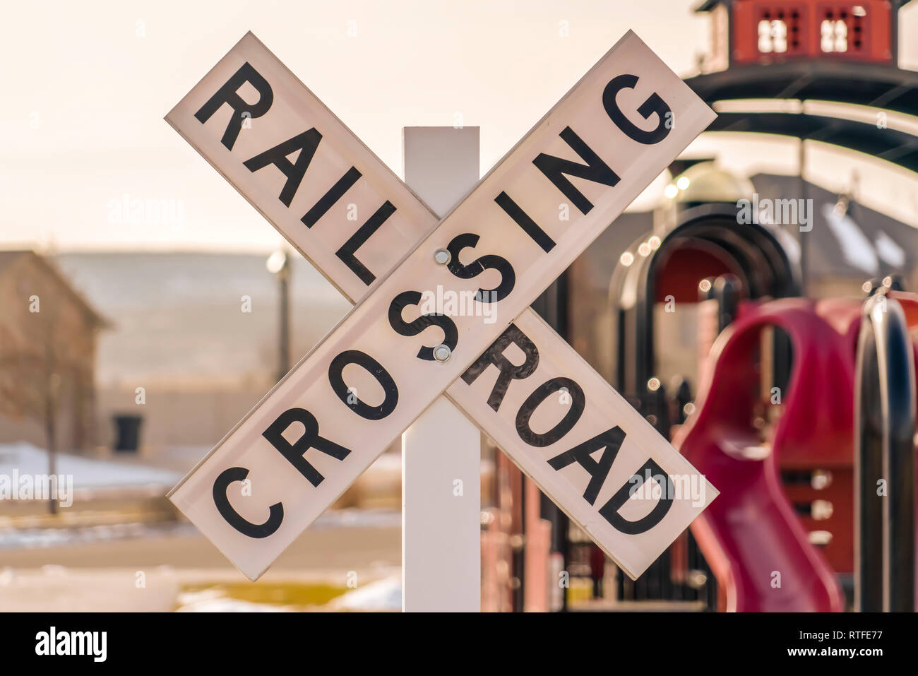 Railroad Crossing sign with playground background. Close up view of a ...