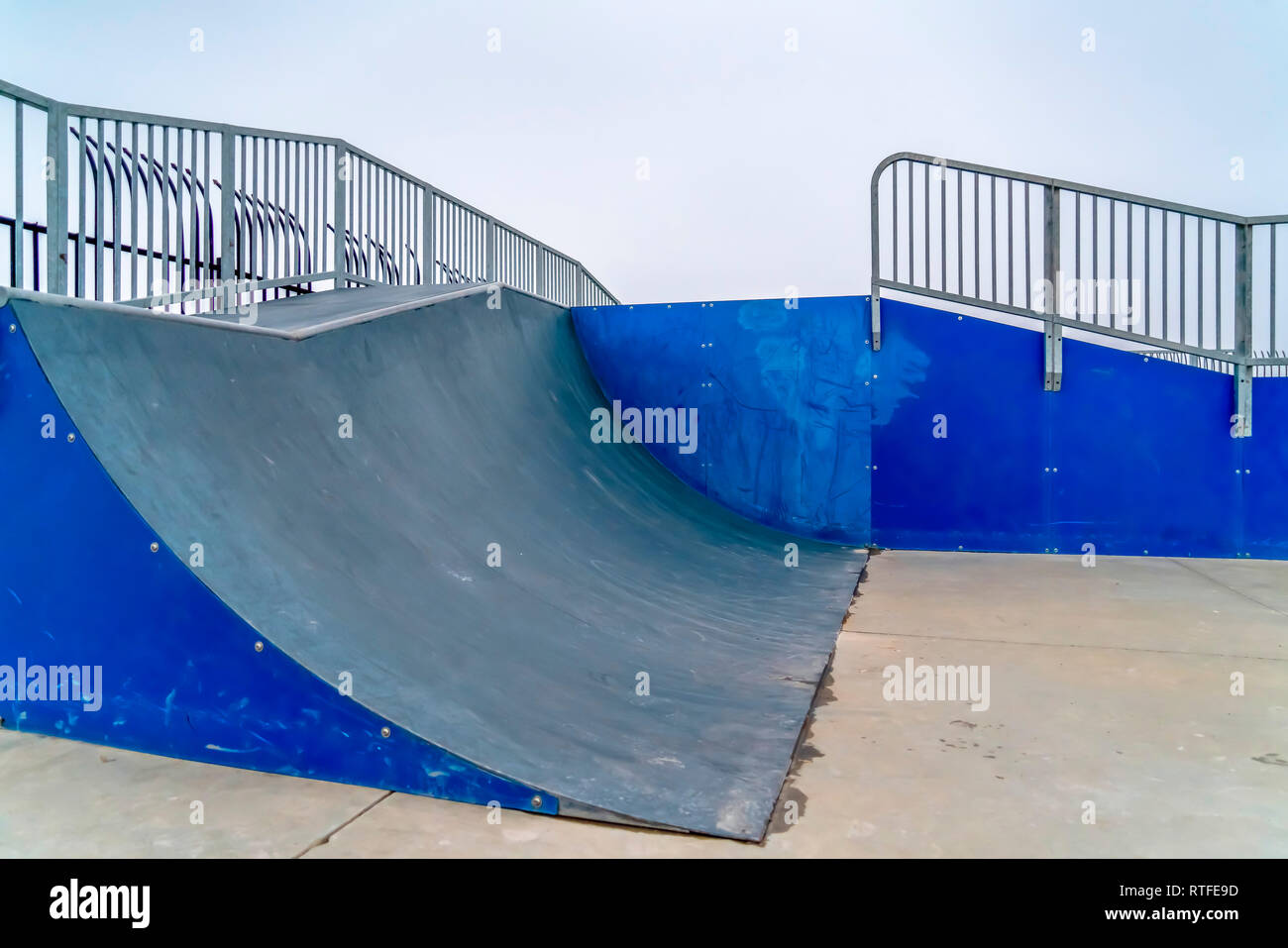 Skateboarding ramp with railings against sky. View of a skateboarding ...