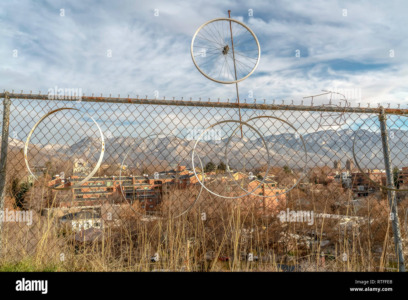 Bike wheel rims hanging on rusty chain link fence. Bicycle wheel rims ...