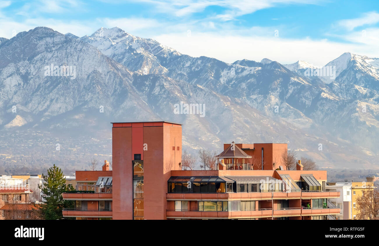 Buildings with Wasatch Mountain and sky background. Buildings and trees ...